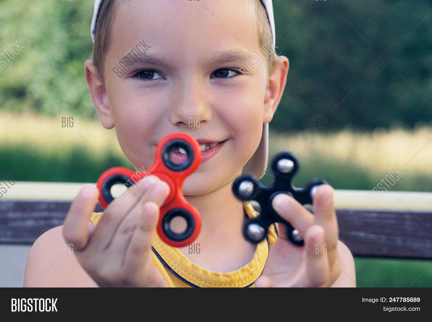 Close Up Portrait Of Young Schoolboy Holding Popular Fidget Spinner To ...