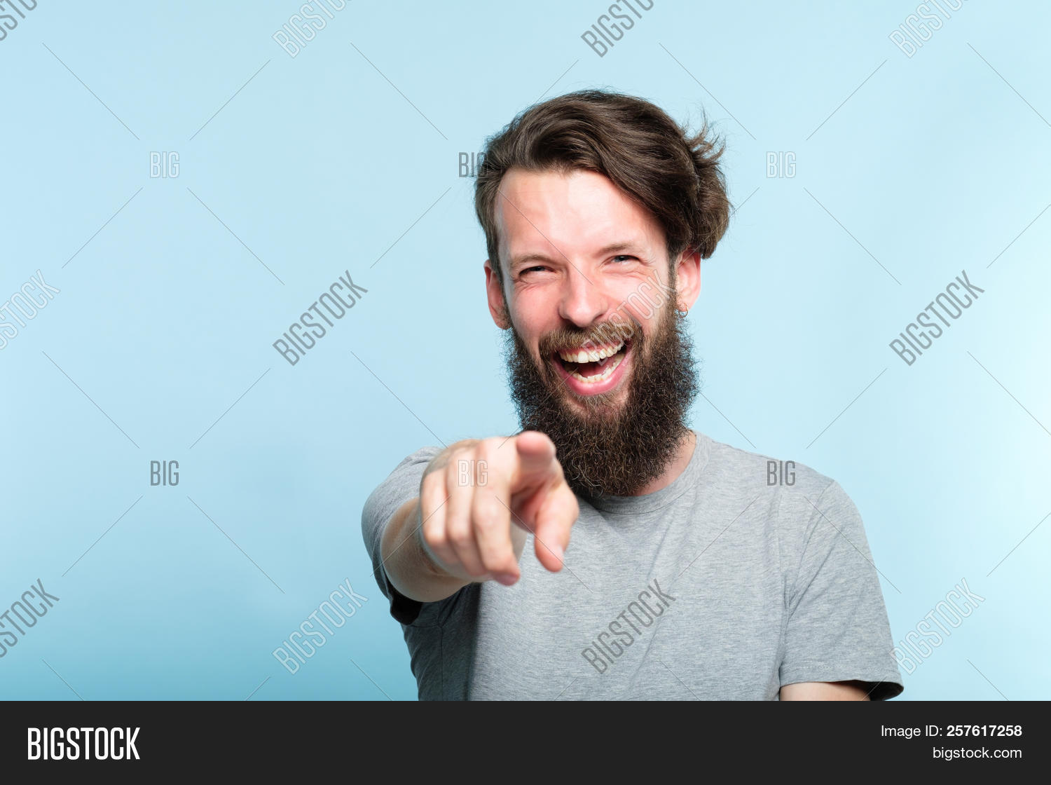 Young Bearded Hipster Man Mocking And Laughing At Viewer Pointing ...