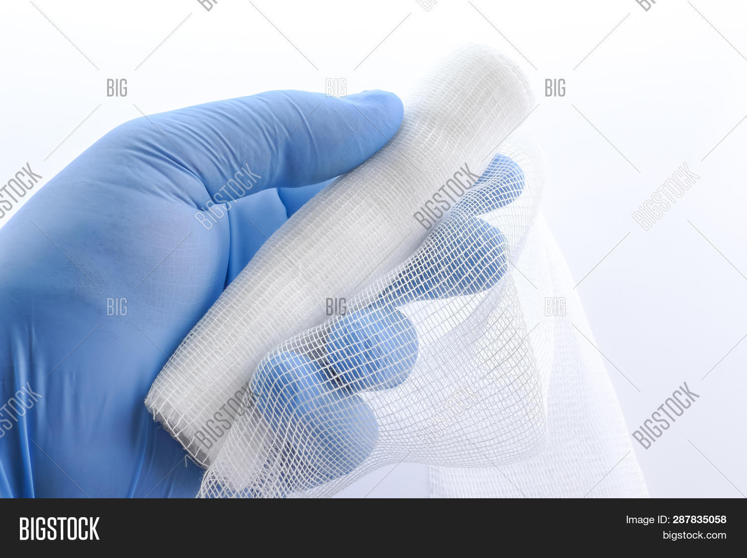 A Sterile Bandage In A Hand. Hand Holding A Sterile Bandage. Roll Of ...
