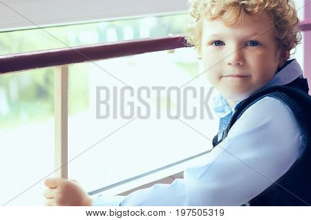 Primary school student standing near the school window. - Stock Image ...