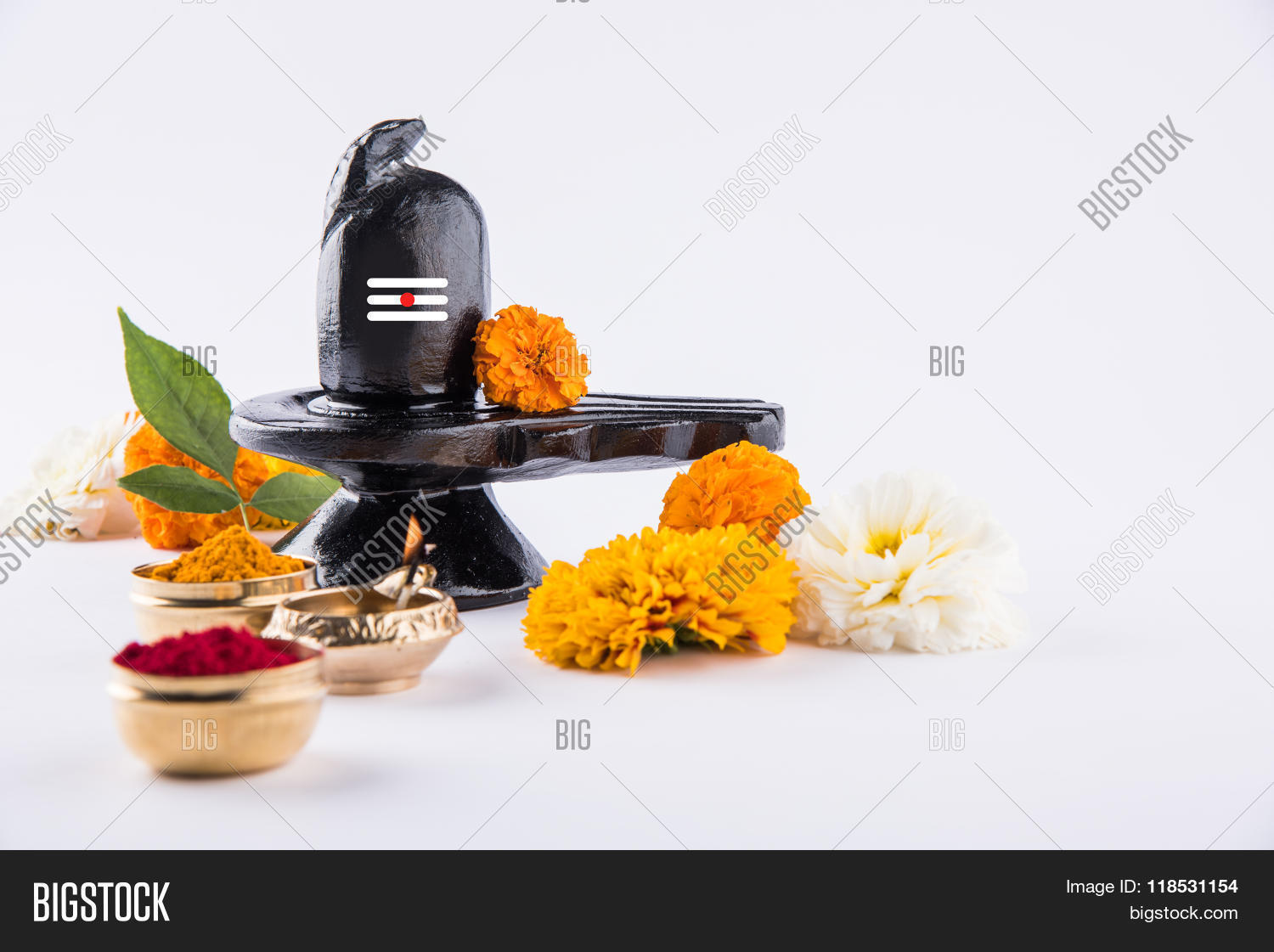Shiva Linga made up of black stone decorated with flowers & bael leaf ...