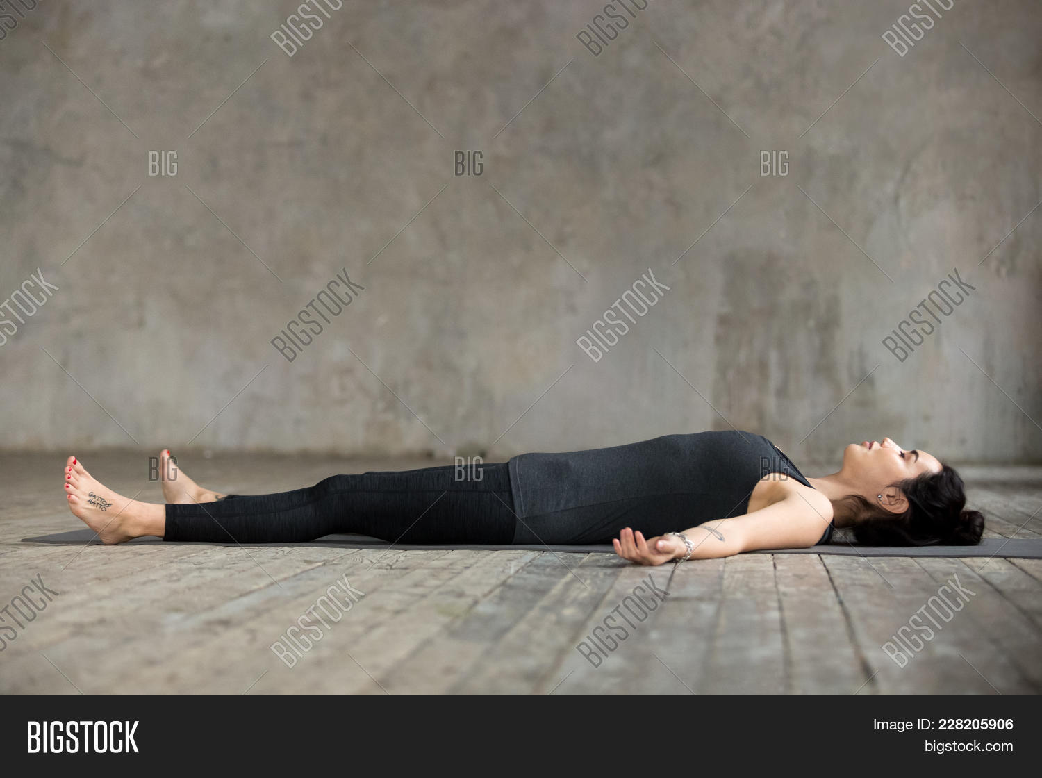 Young Sporty Woman Practicing Yoga, Lying In Dead Body Or Corpse Pose ...