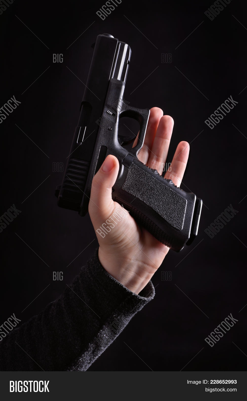 Hand Holding A Semi Automatic Handgun (glock) On A Black Background ...