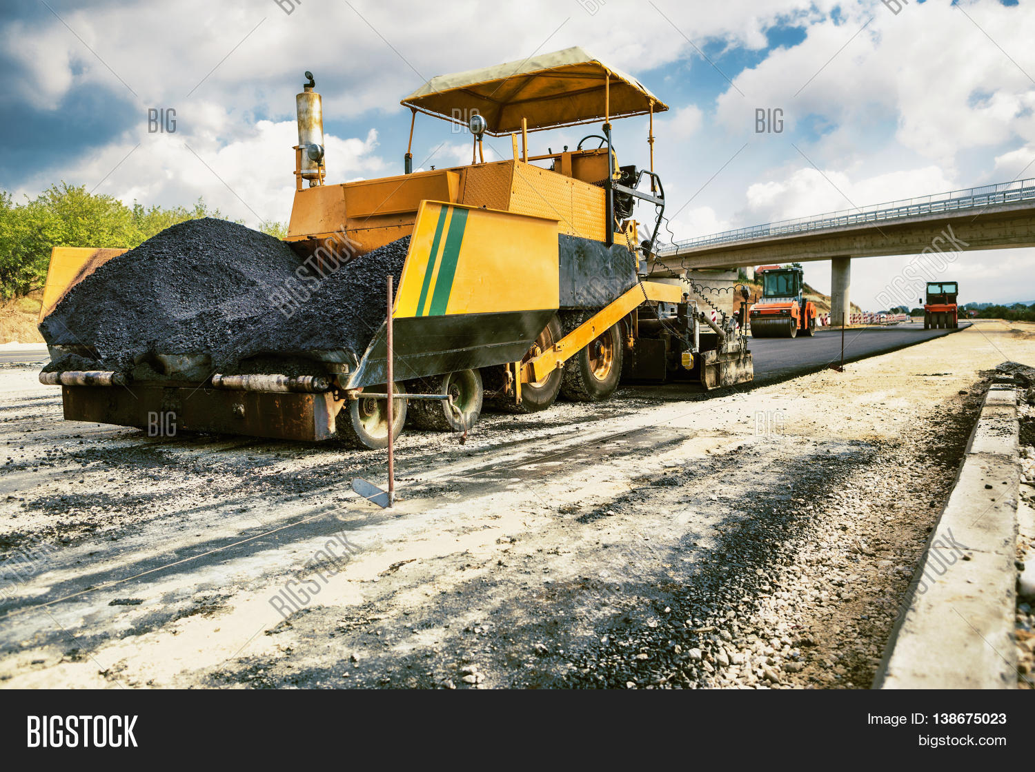 New Road - Pavement machine laying fresh asphalt or bitumen on top of ...