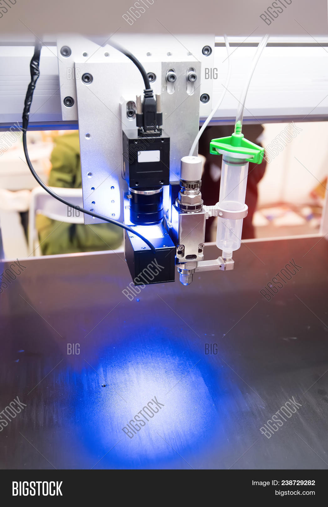 Robot holding glue syringe Injection with robotic machine vision system ...