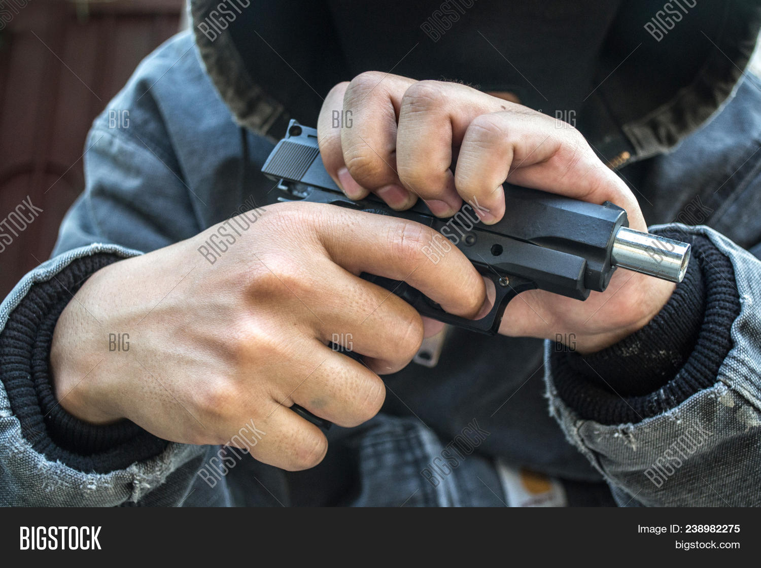 A Man Holding A Gun On His Back. The Gunman Held His Gun Behind Him ...