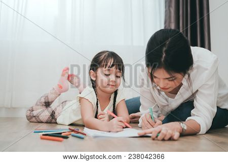 Mother And Daughter Study Drawing With Crayon Paint On The Paper Family ...