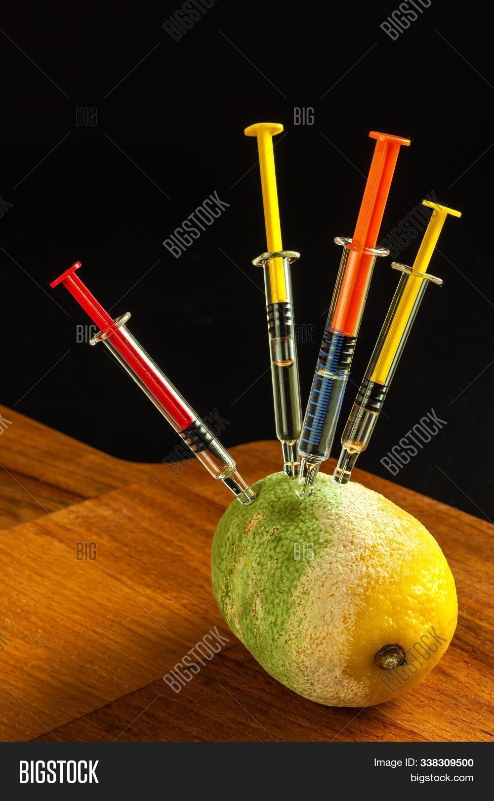 Moldy Lemon With Syringe. Chemistry In Food. Unhealthy Food. Decayed ...