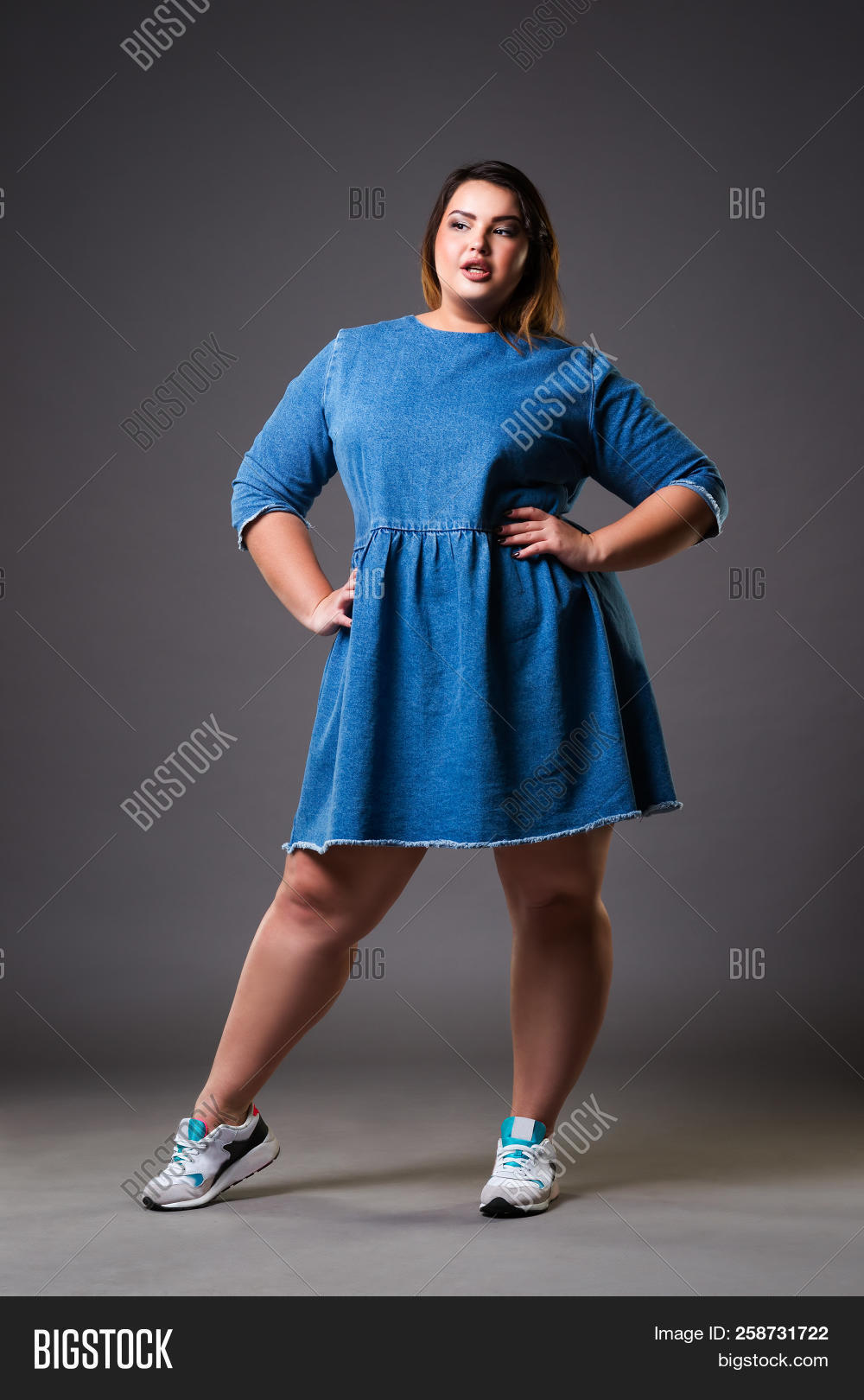 Plus Size Model In Denim Dress, Fat Woman On Gray Studio Background ...