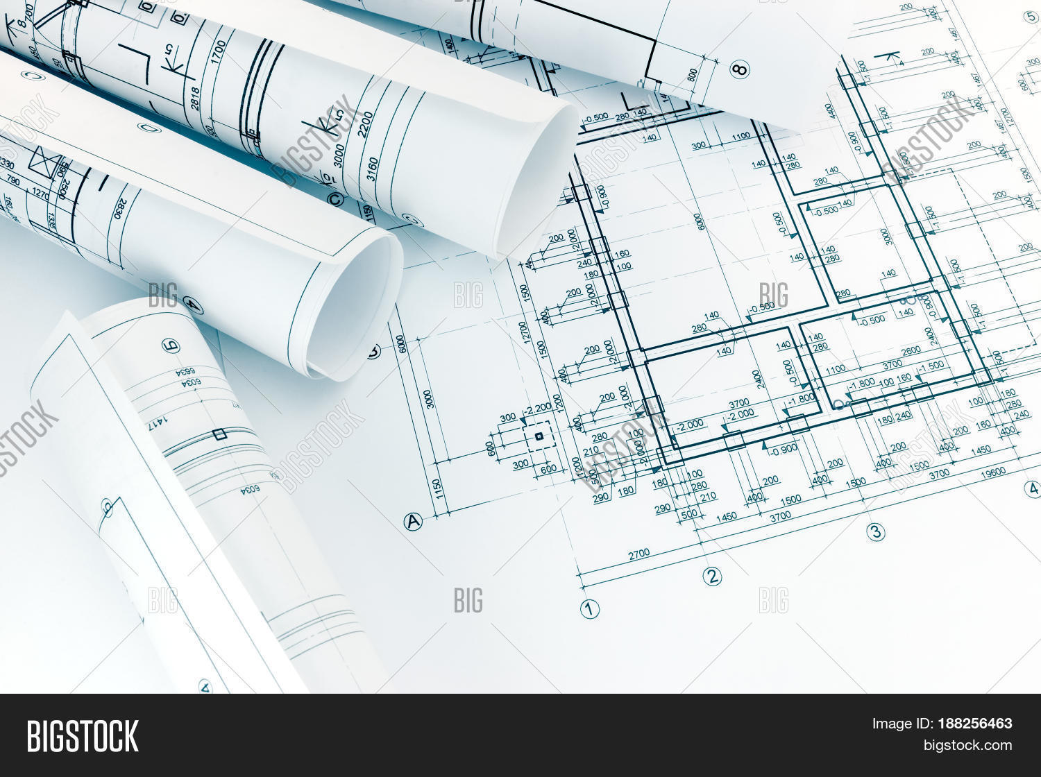Rolls Of Architecture Blueprints With Floor Plan Drawing On Architects ...