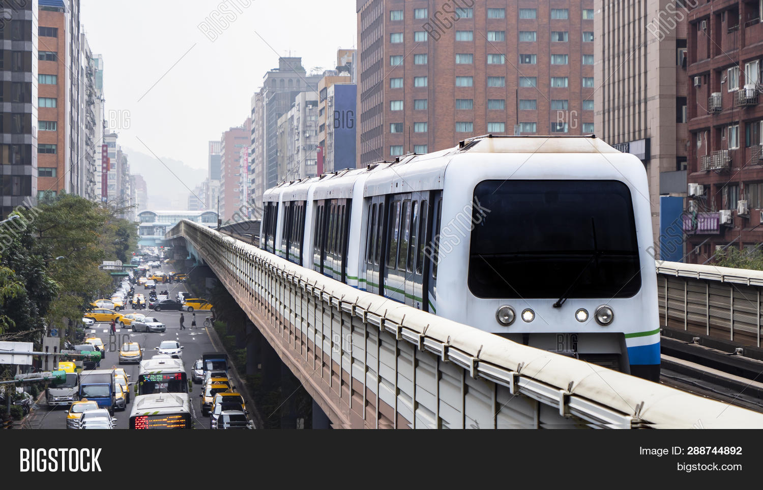 Mass Rapid Transit (mrt) Train On The Rail Track With Modern Building ...