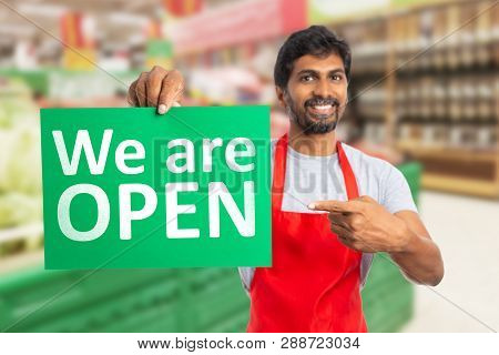 Friendly Man Working At Hypermarket Or Supermarket Pointing With Index ...