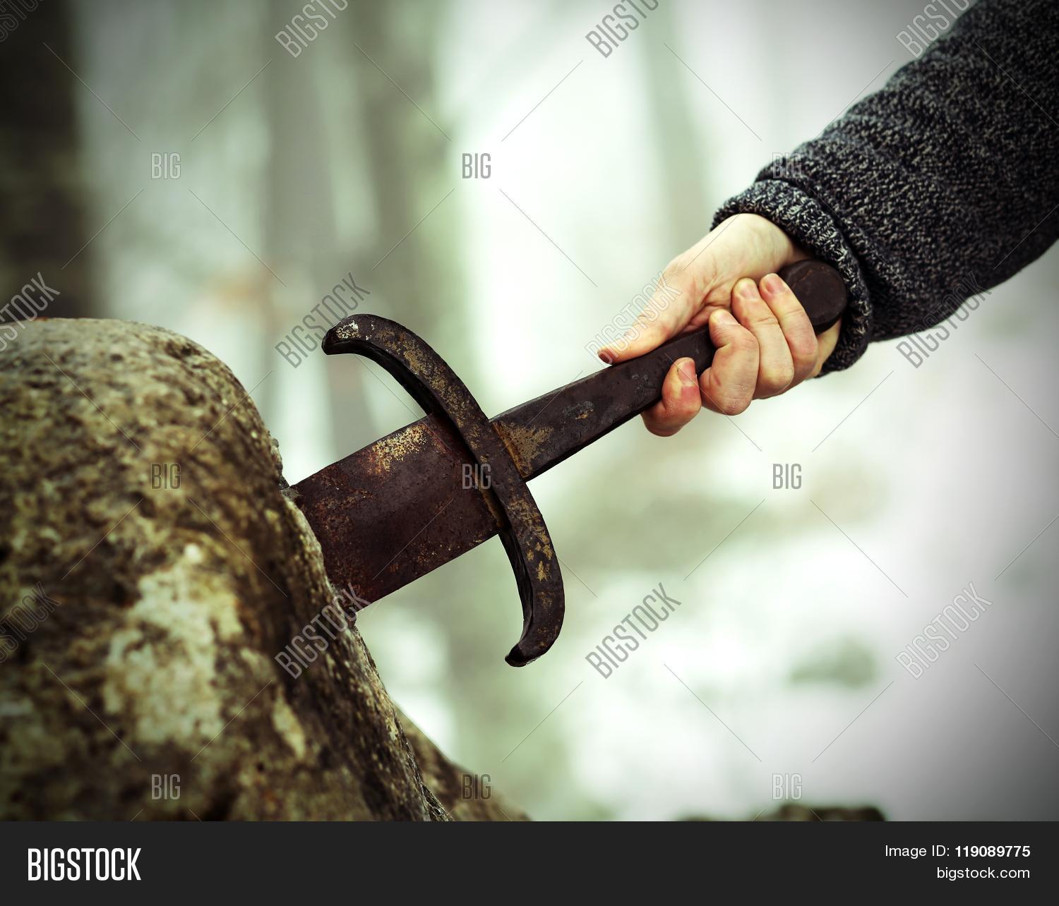 Knight Tries To Remove Excalibur Sword In The Stone image & stock photo ...