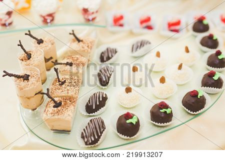 Different kinds of baked sweets on a buffet. - Stock Image - Everypixel