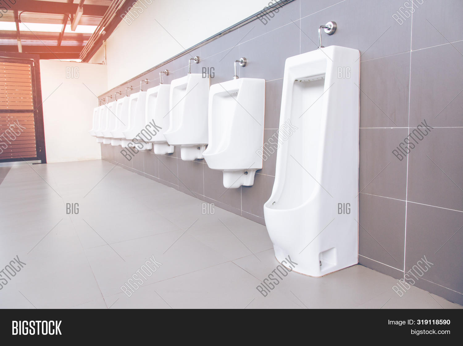 Men's Room With White Porcelain Urinals In Line. Modern Clean Public ...