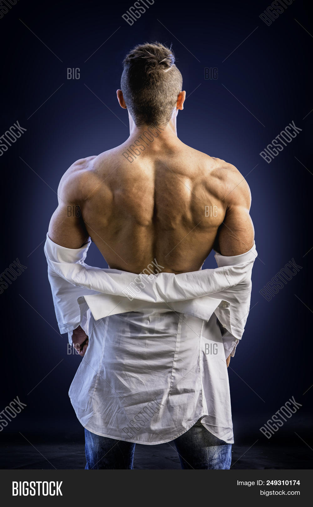 Rearview Of Back Of Male Bodybuilder Opening His Shirt Revealing ...