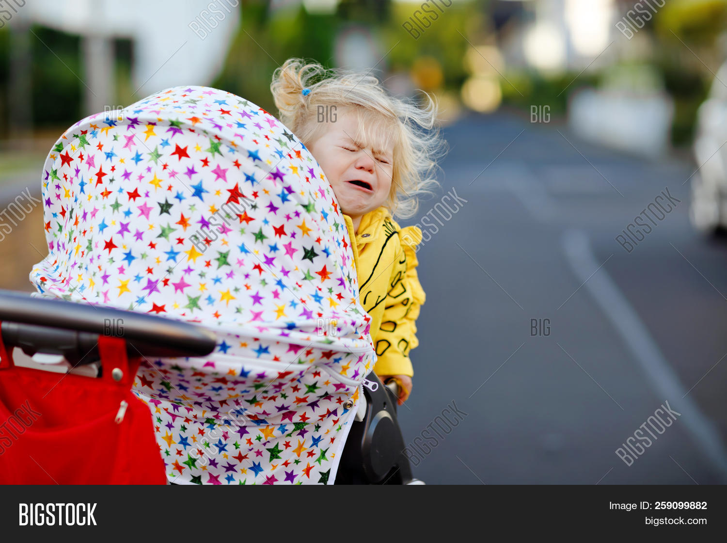 Portrait Of Little Sad Toddler Girl Sitting In Stroller And Going For A ...