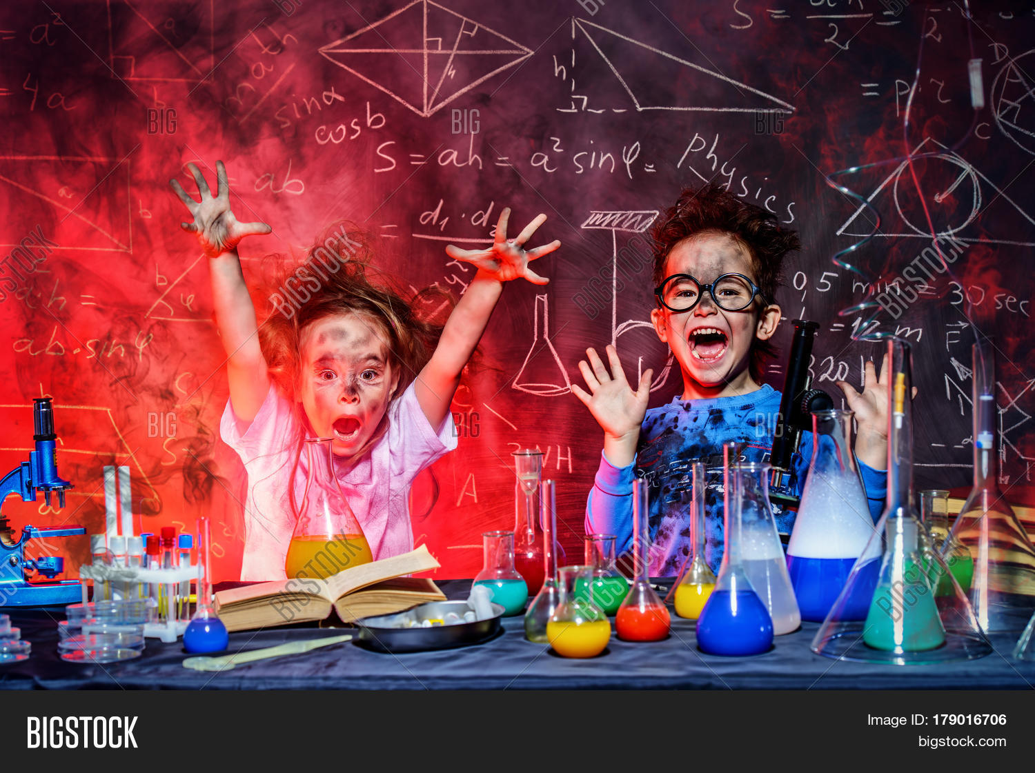Funny little children doing experiments in the laboratory. Explosion in ...